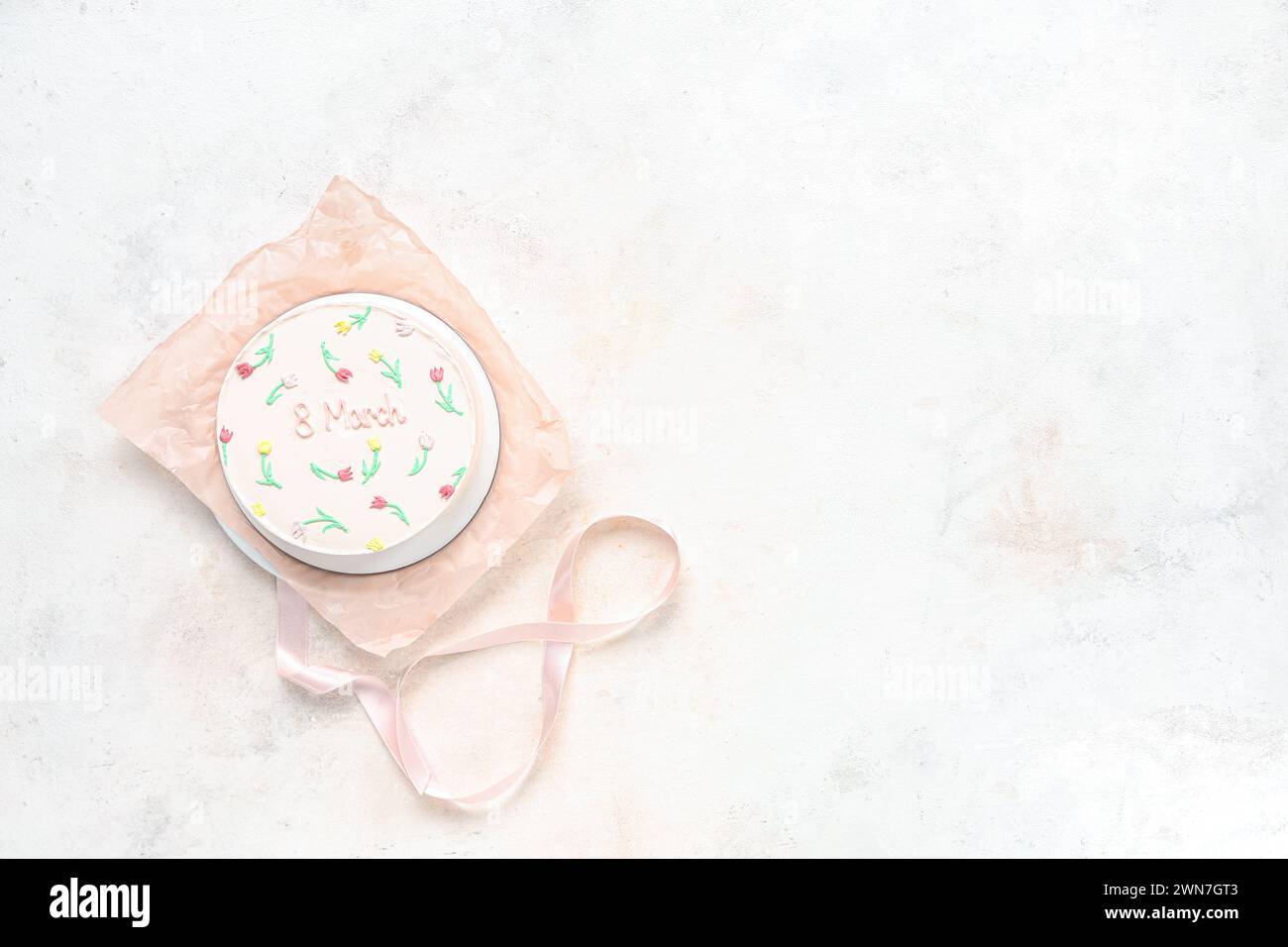 Sweet bento cake and figure 8 made of ribbon on white background ...