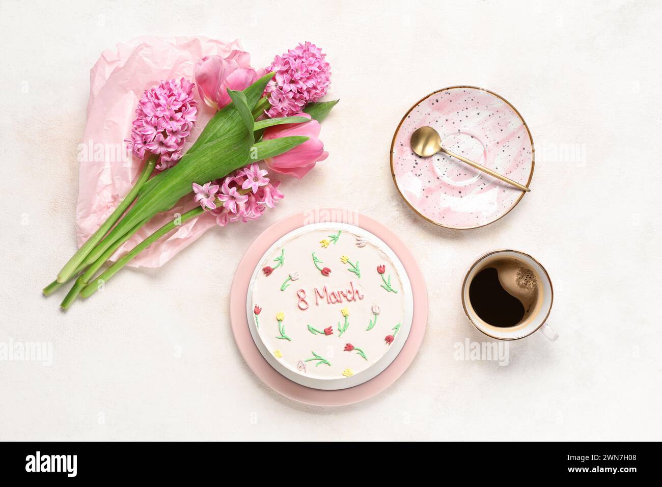 Sweet bento cake with cup of coffee and beautiful flowers on white ...