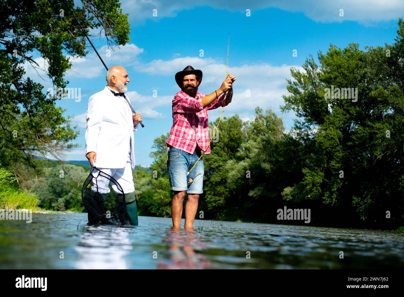 Mature senior man with friend fishing. Summer vacation. Happy cheerful ...