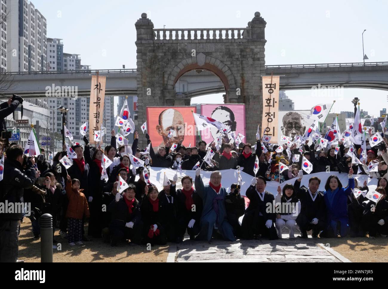 South Koreans wave their national flags during a ceremony to celebrate ...