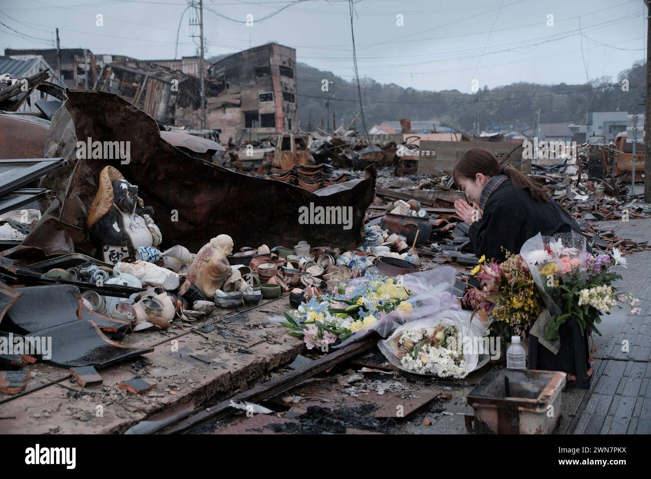 People mourn the victims at the devastated Wajima Morning Market in ...