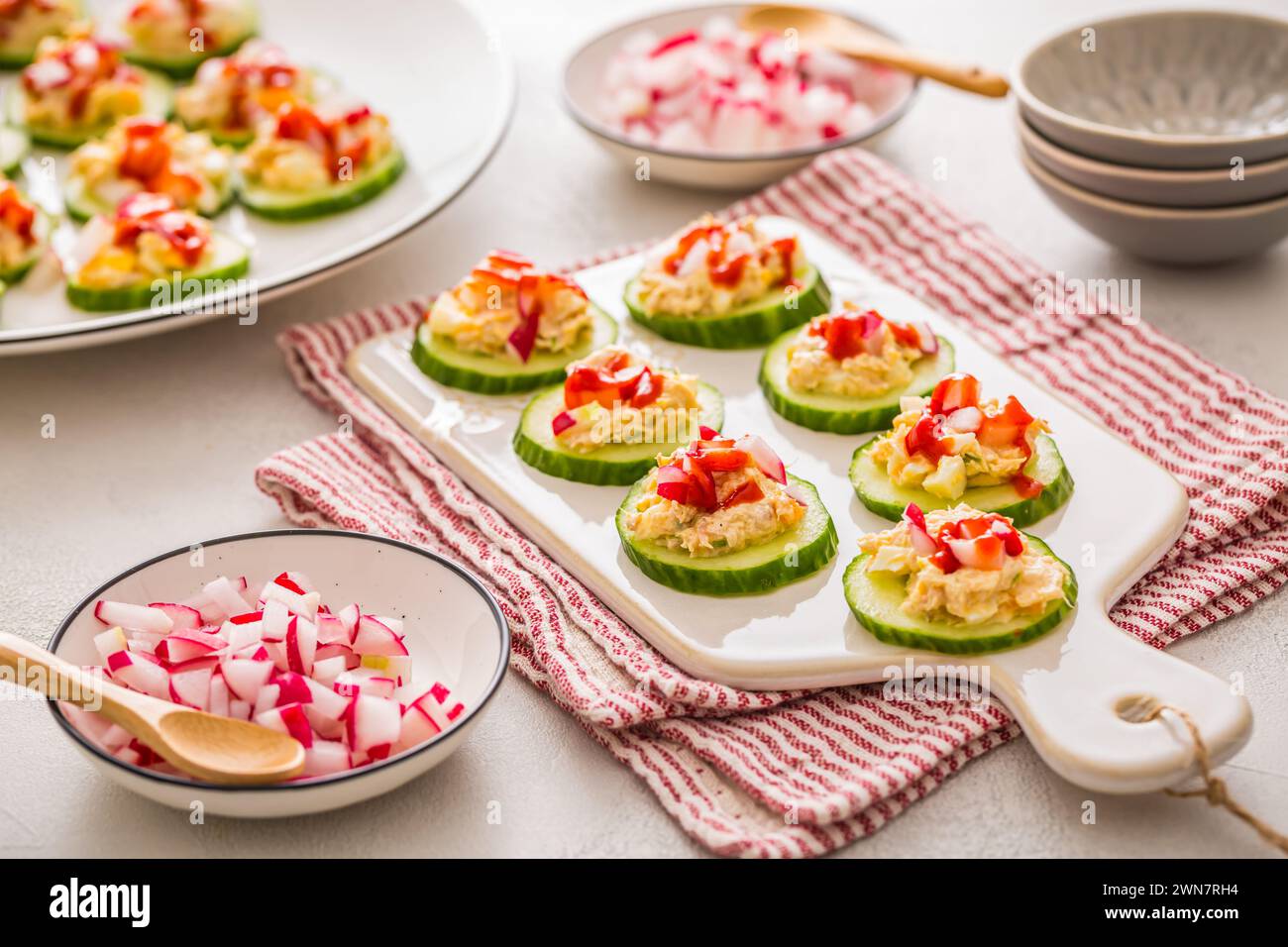 Cucumber appetizers with tuna and salmon spread with radish, fingerfood ...