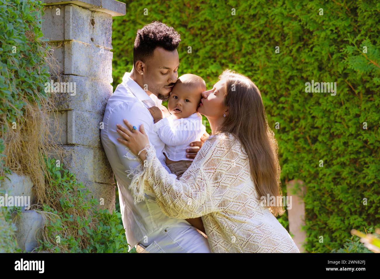 Mixed raced parents and Biracial baby outdoor portrait. Multiracial ...