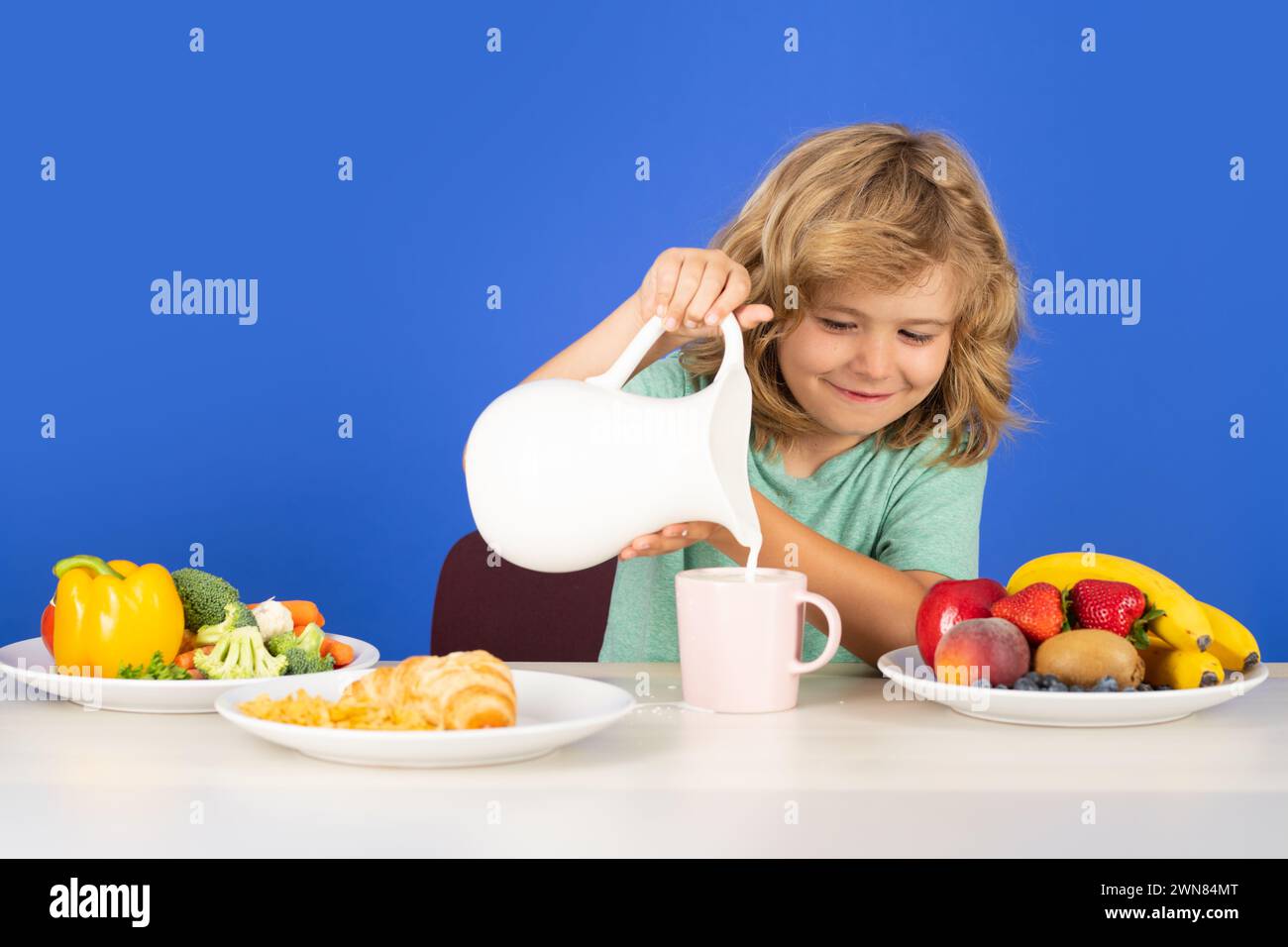 Kid boy pouring whole cows milk. Portrait of child eat fresh healthy ...