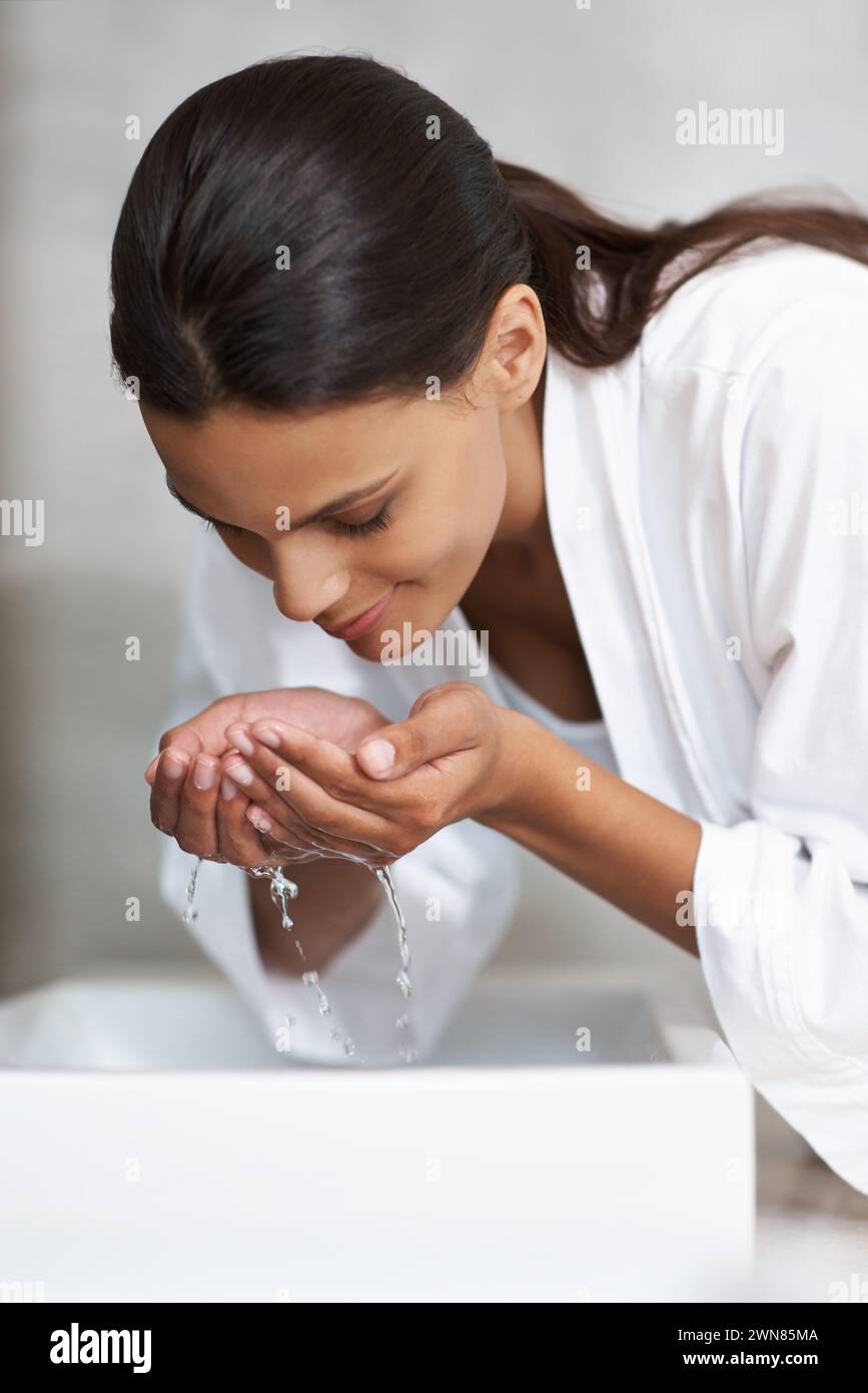 Hands, water and woman wash face for beauty and skincare, wellness and ...