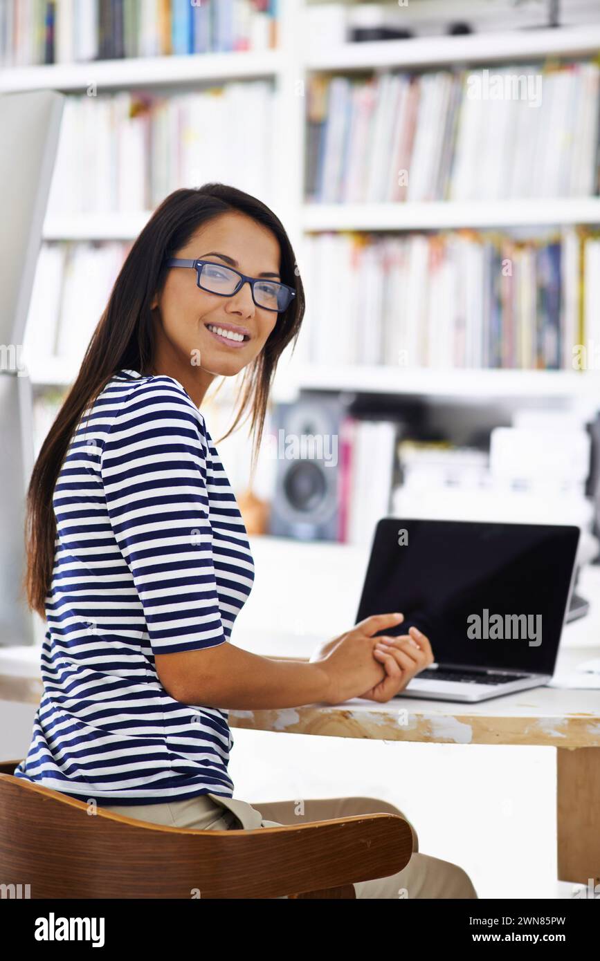 Female, student and smile with laptop at desk in library, confident and ...
