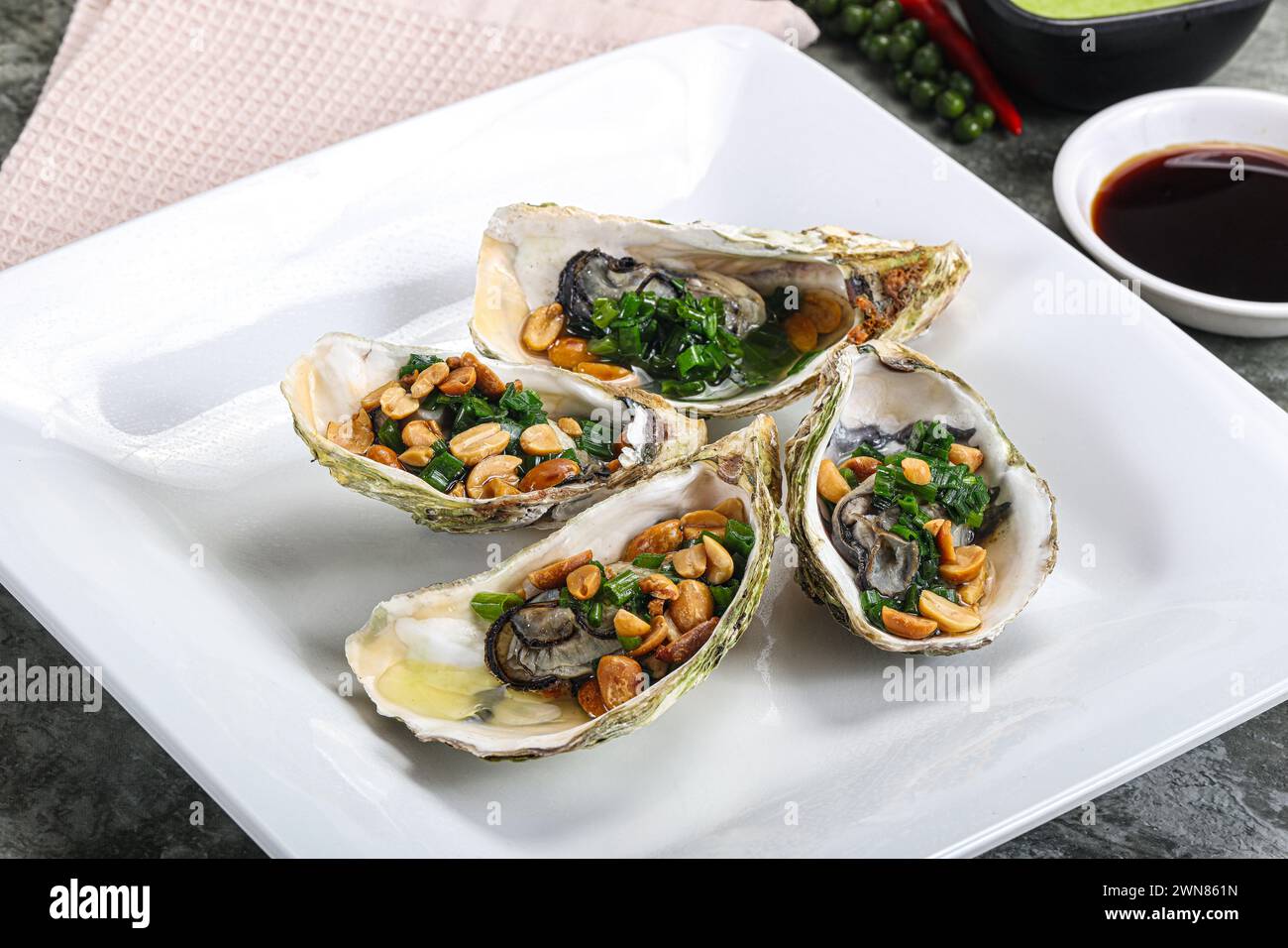 Open half oysters with green onion and peanut Stock Photo - Alamy