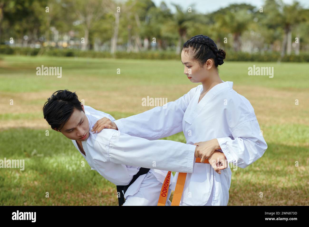 Taekwondo athlete attacking her opponent when fighting outdoors Stock ...