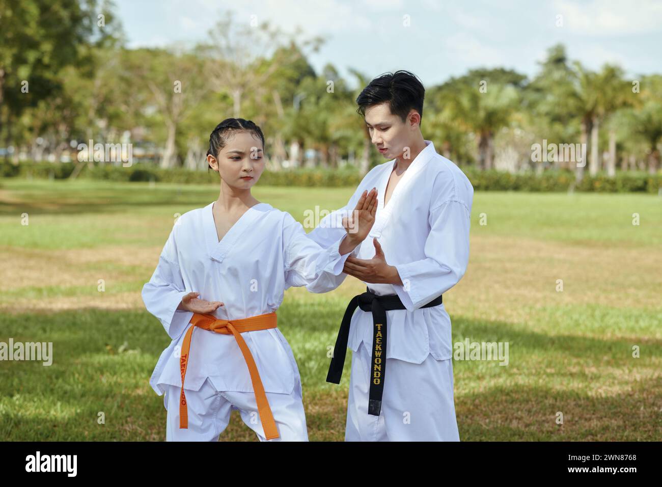 Instructor explaining female athlete how to position arms when doing ...