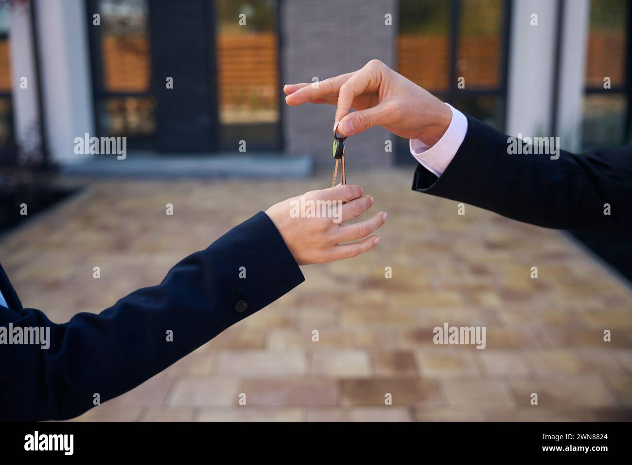 Man hand giving keys and woman hand taking them Stock Photo - Alamy