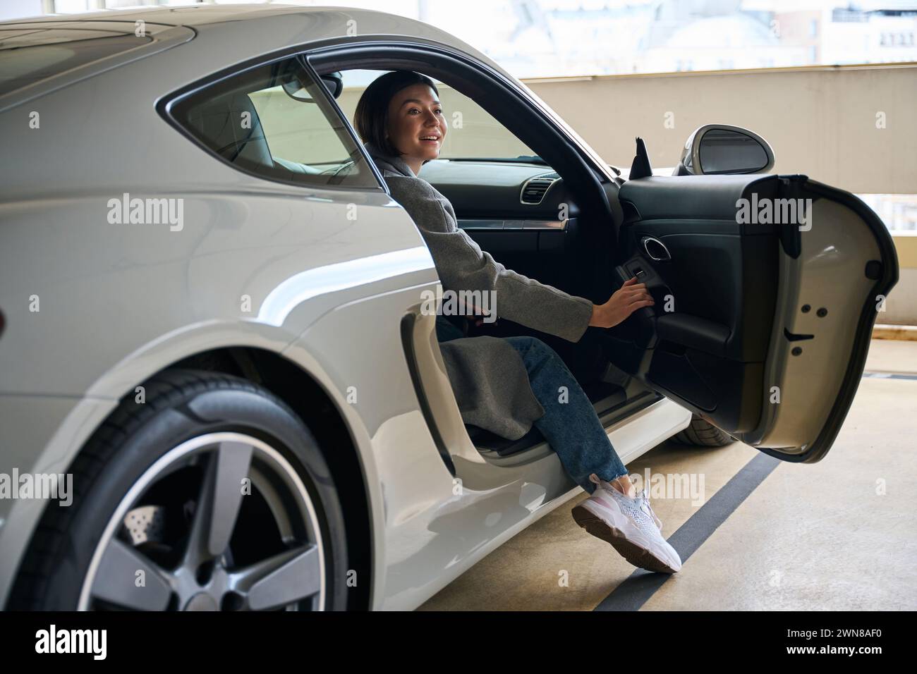 Pretty lady entering or exiting of car Stock Photo - Alamy