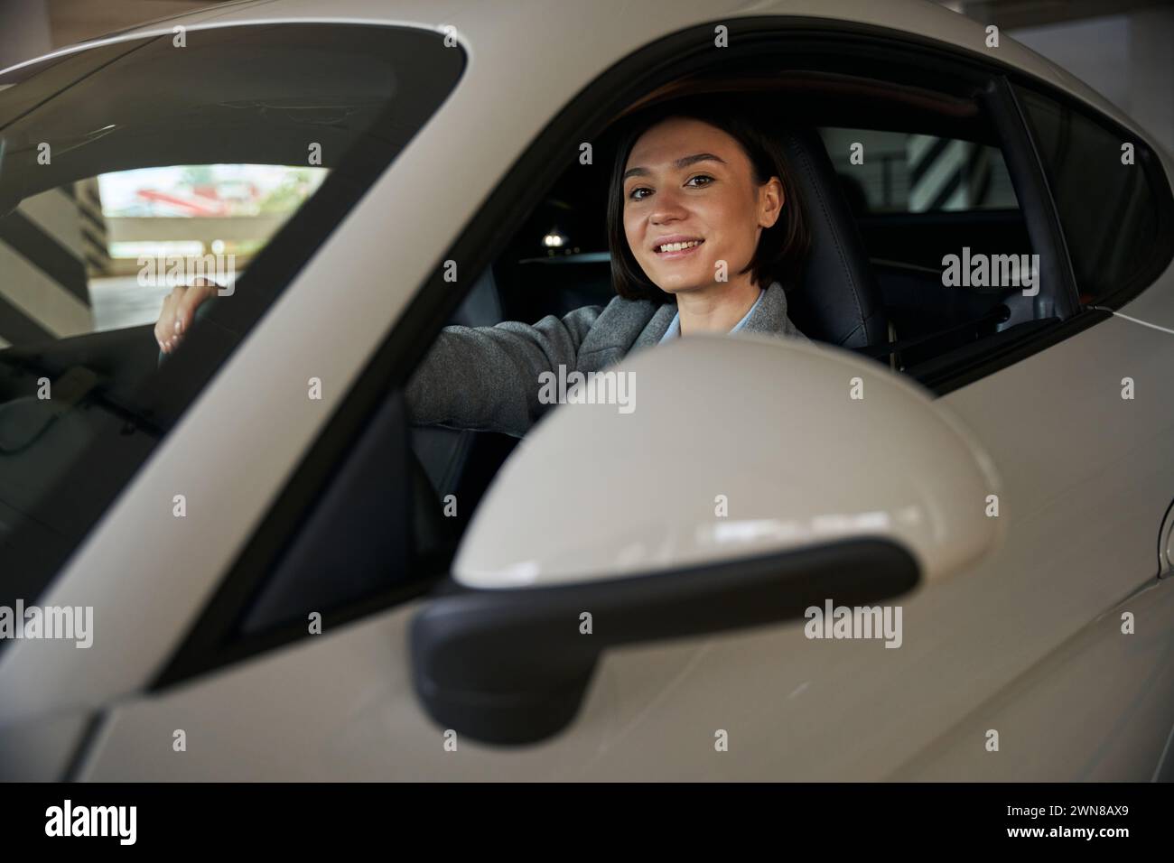 Attractive pretty business lady ready to drive Stock Photo - Alamy