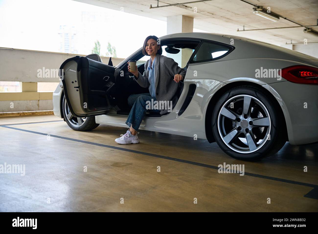 Beautiful lady entering or exiting of car Stock Photo - Alamy