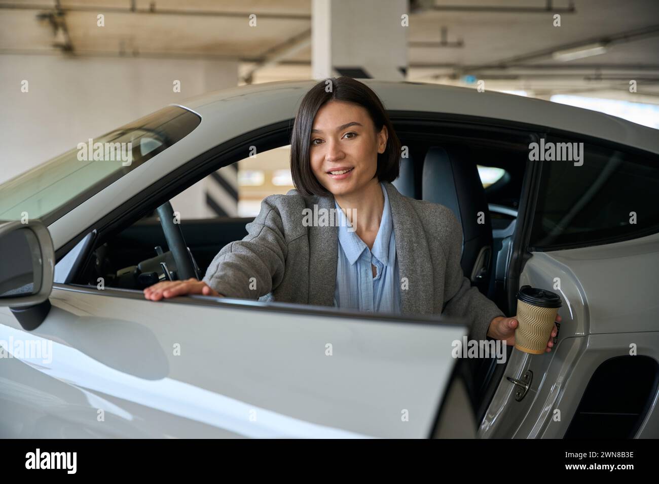 Beautiful attractive woman driver opening or closing car door Stock ...