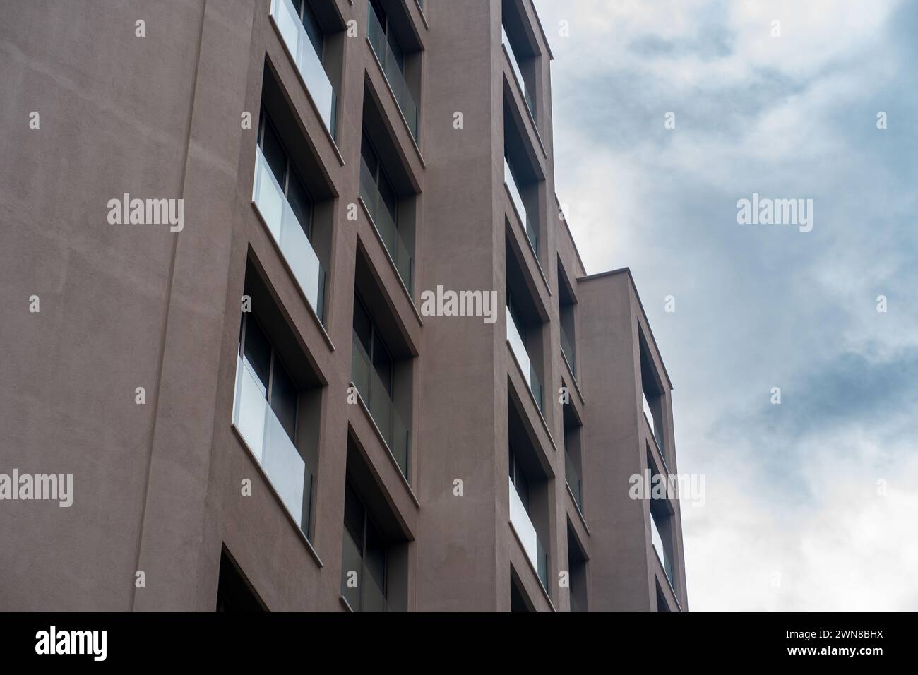 Brown wall facade perspective. Building balconies with glass safety ...