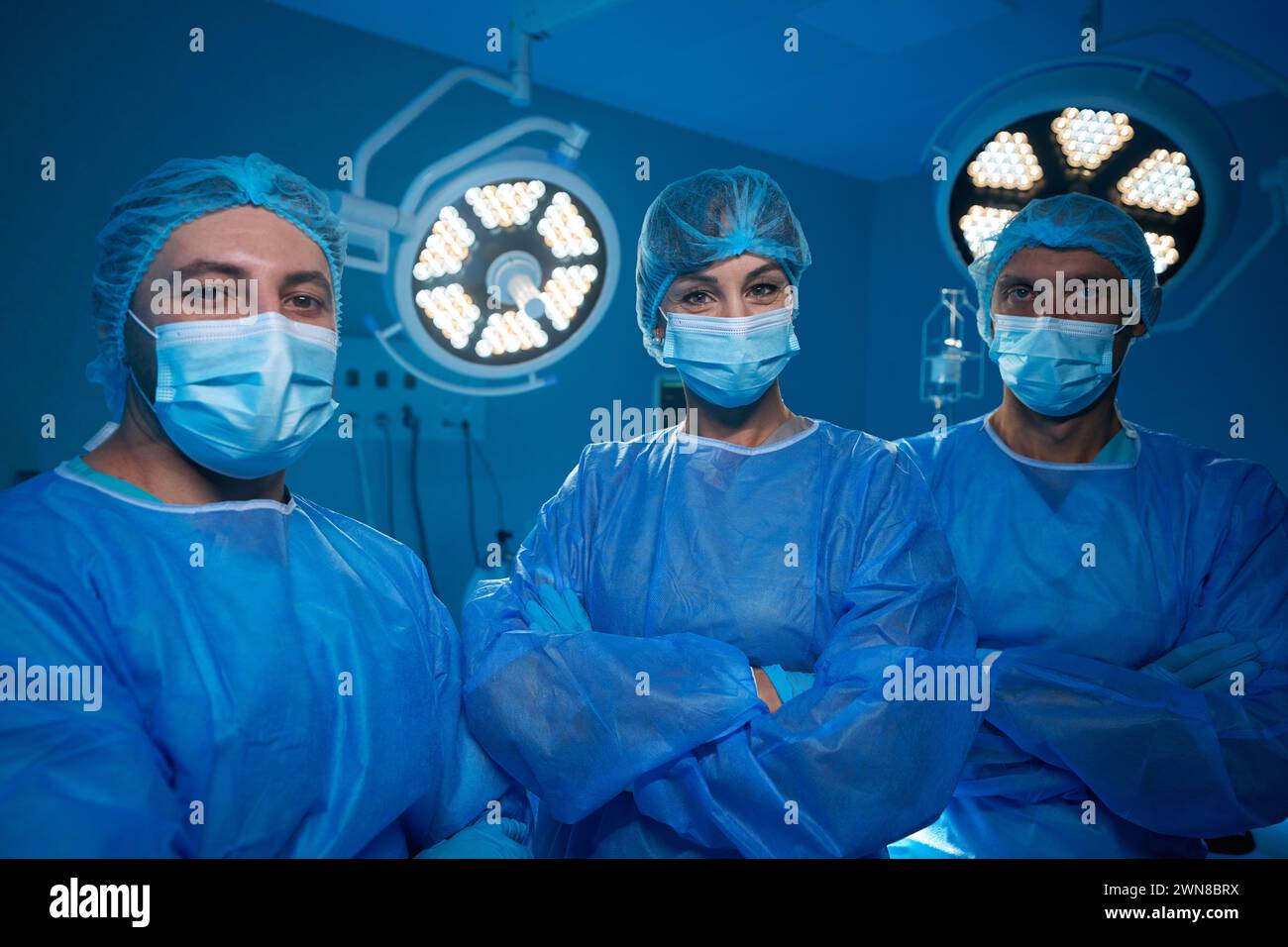 Professional surgeons in hospital operating theater wearing sterile ...