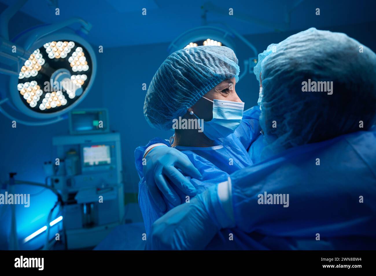 Surgical doctors celebrating successful operation and hugging Stock ...