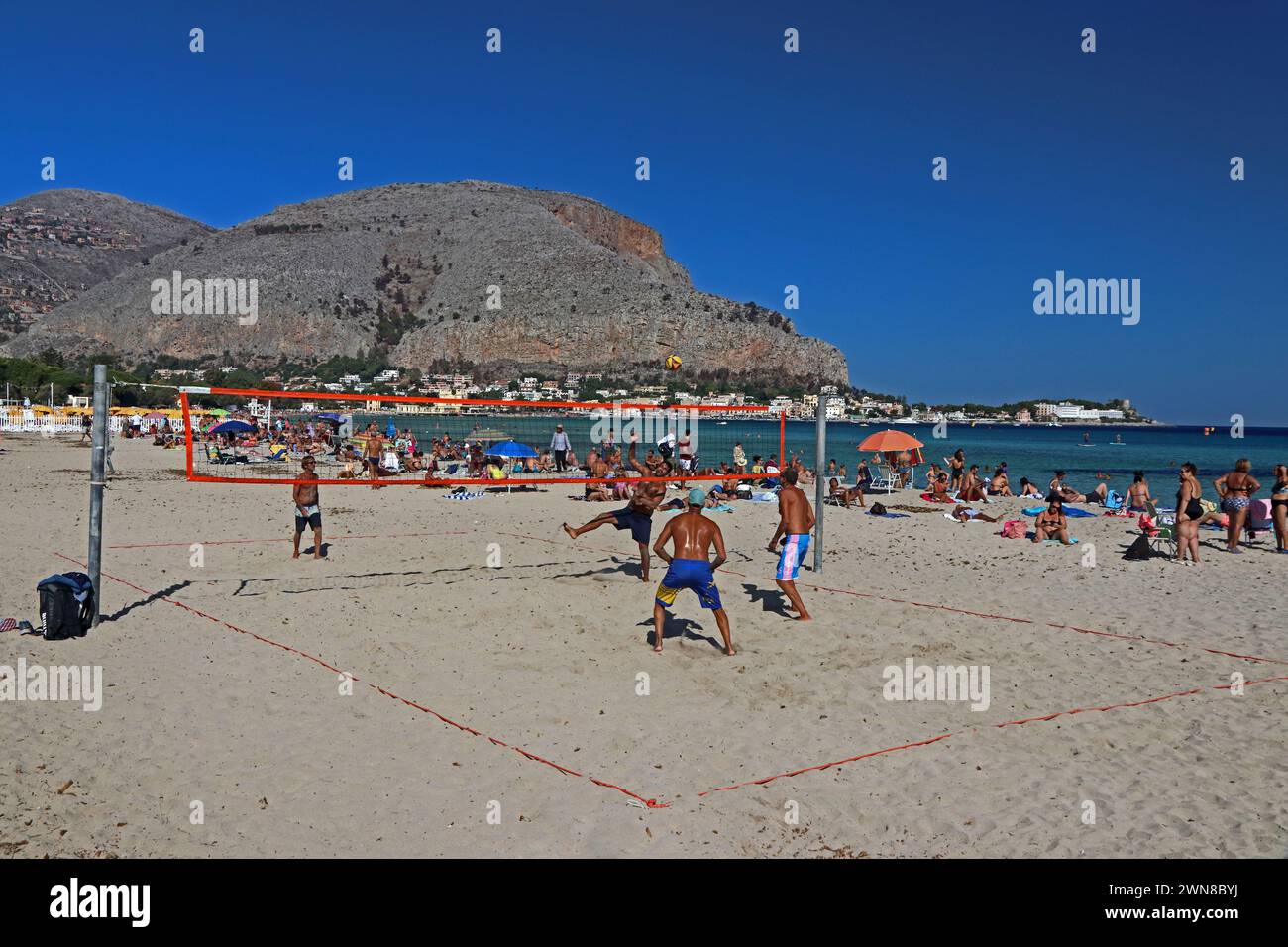 Young men playing beach volleyball, Mondello, Palermo, Sicily Stock ...