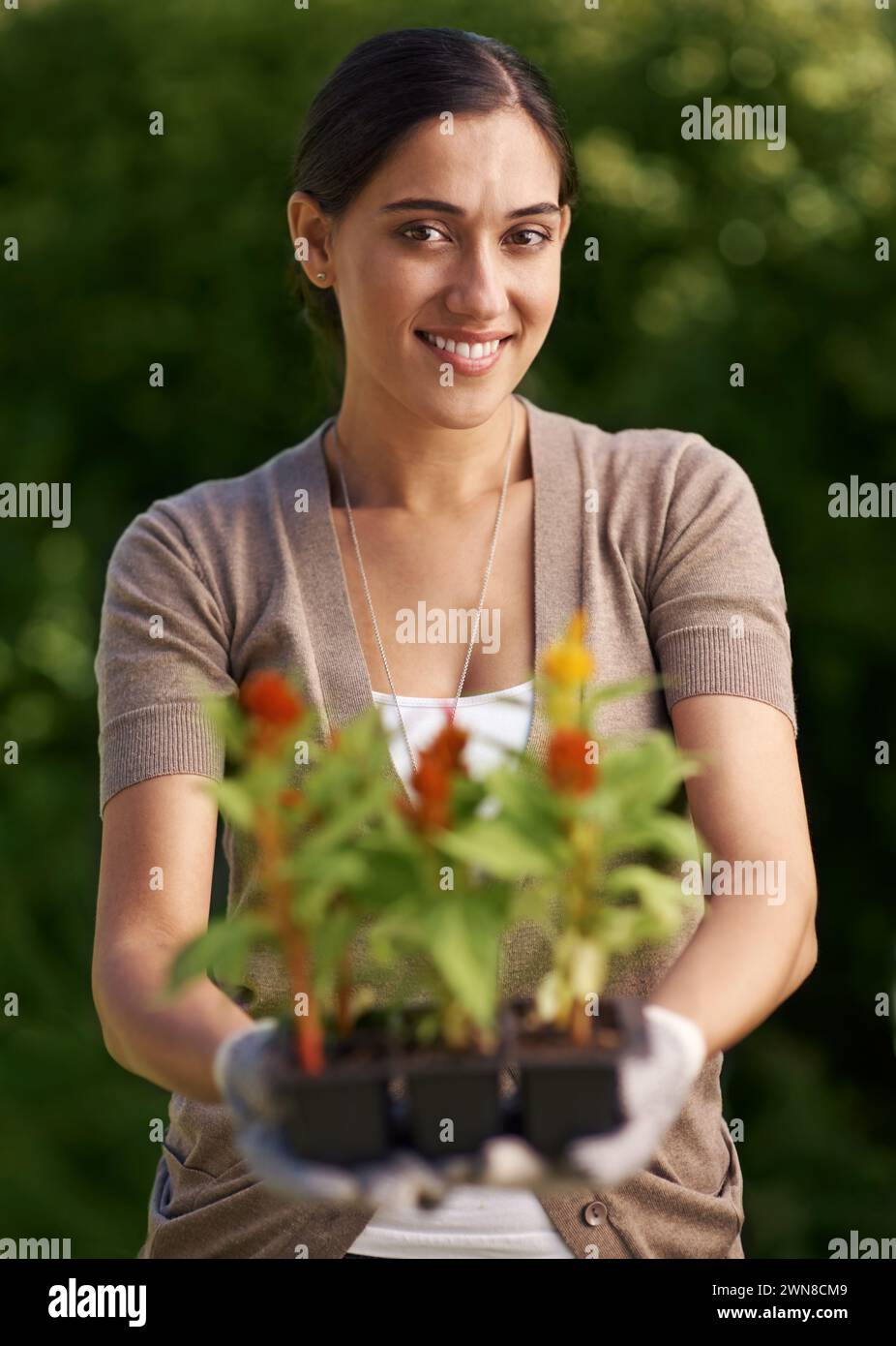 Nature, gardening and portrait of woman with flower plant in backyard ...