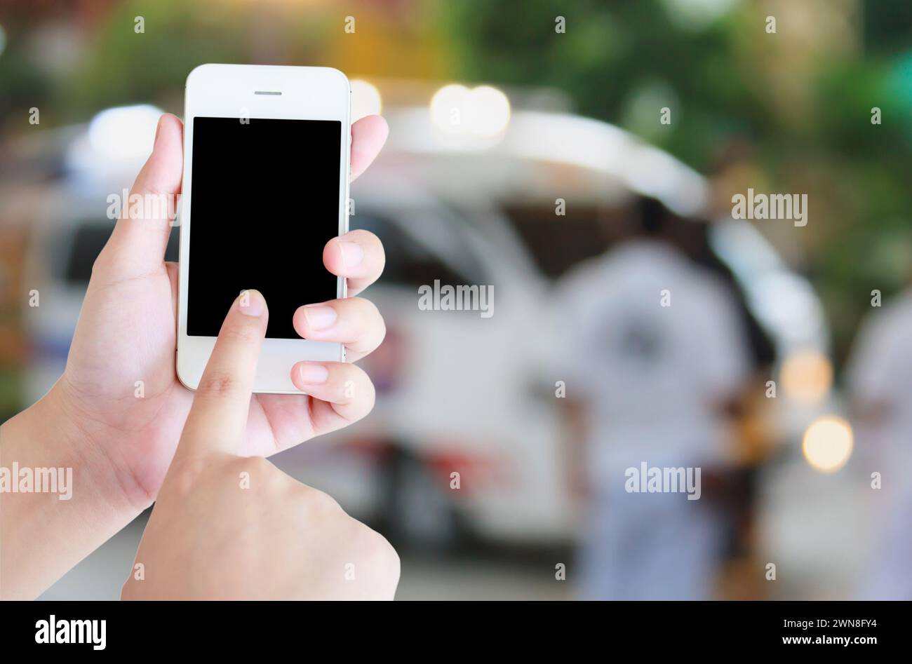 hand hold smartphone with Ambulance responding to an emergency call ...
