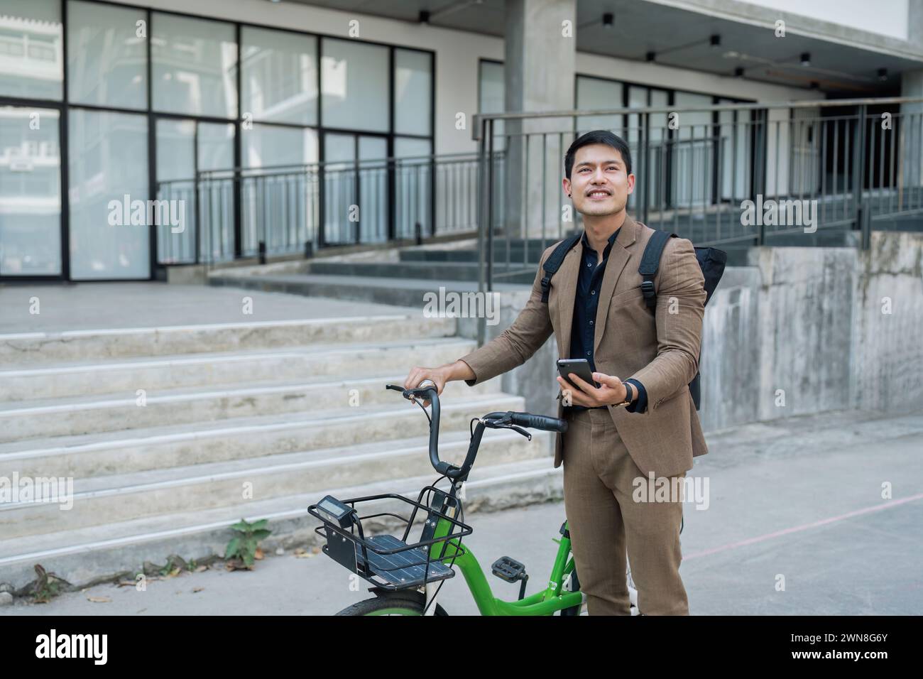 Businessmen ride bicycle to work to reduce carbon dioxide emissions and ...