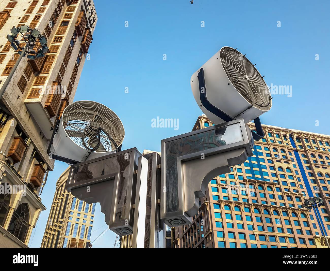 Electronic fans cool the atmosphere in the courtyard of Masjid Al Haram ...