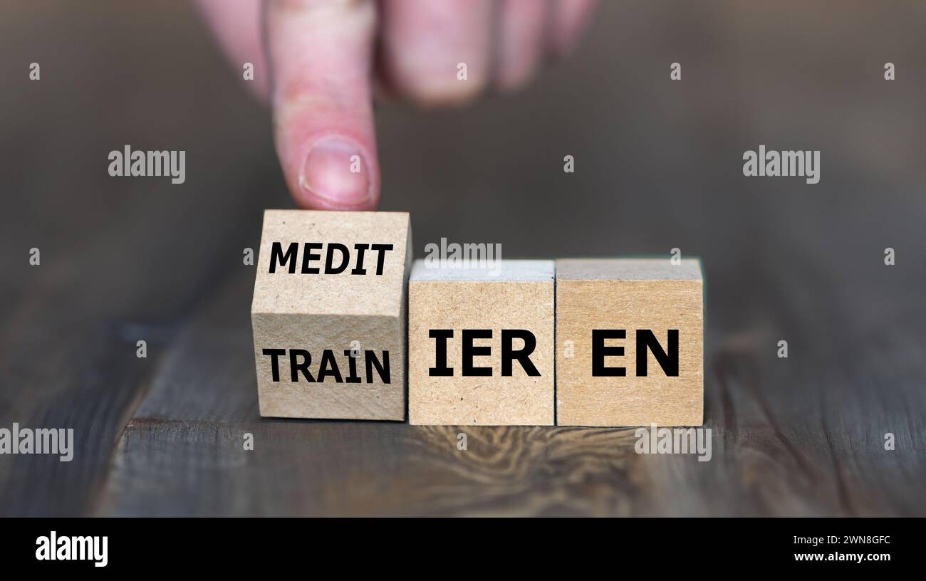 Wooden cubes show the German words 'meditieren' (meditation) and ...