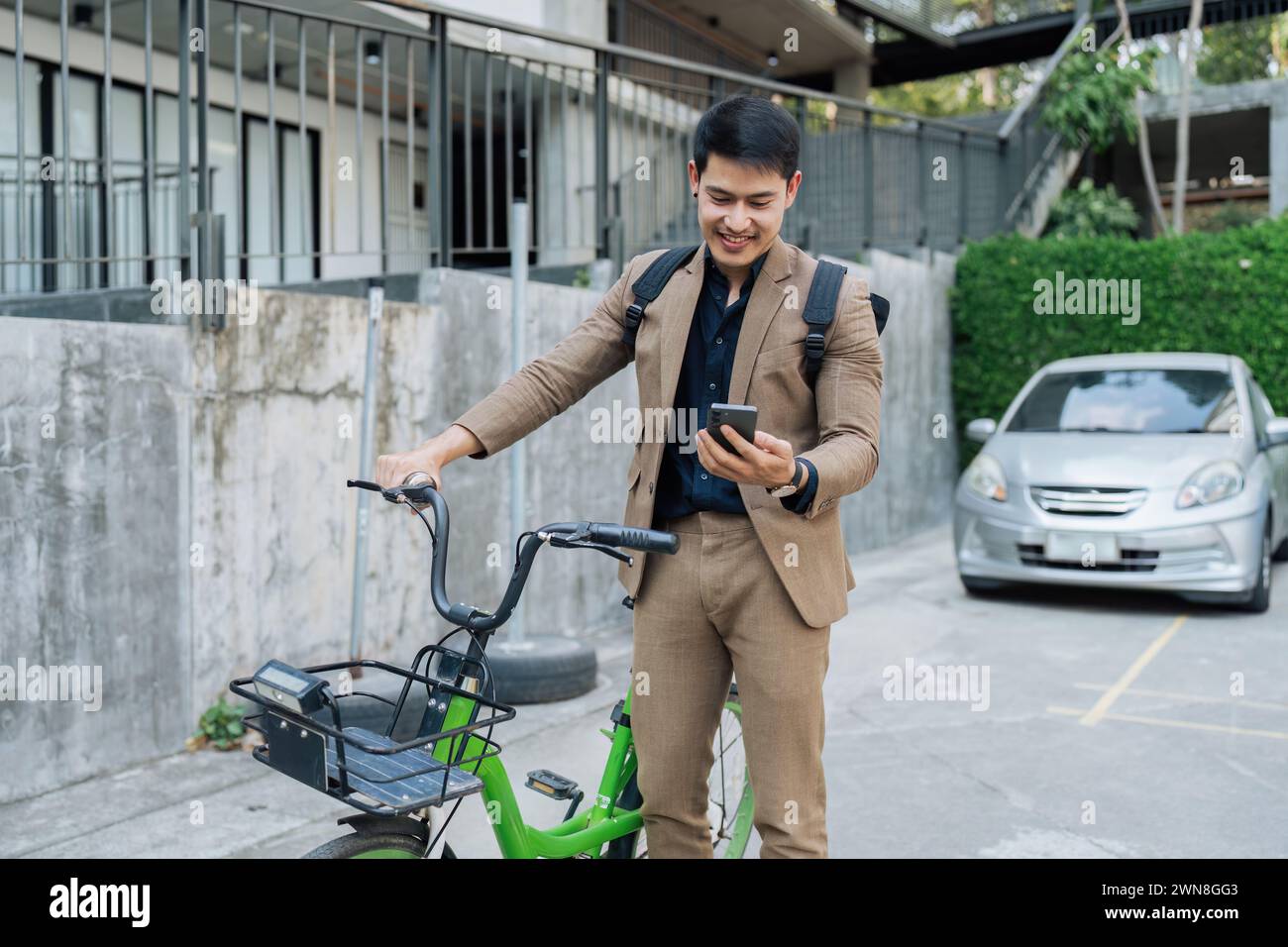 Businessmen ride bicycle to work to reduce carbon dioxide emissions and ...