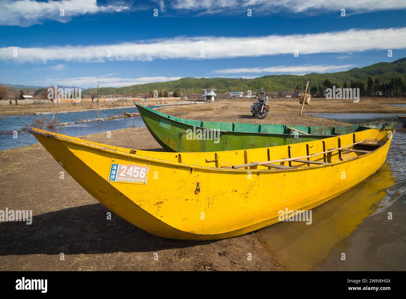 Colorful metal rowing boats and motorcycle at Lashi lake, Yulong ...