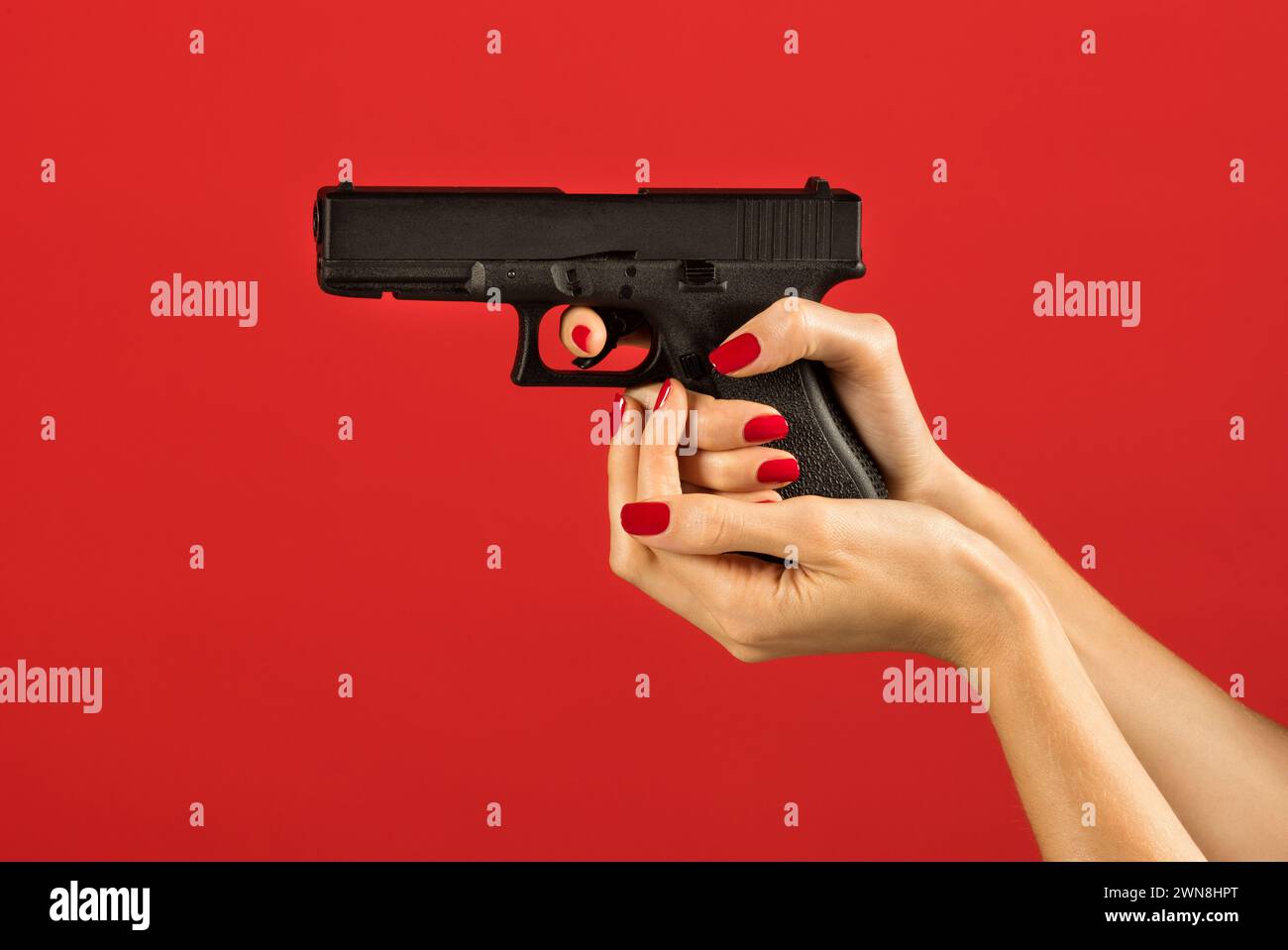 Unrecognizable slim woman holding pistol grip in right hand while ...