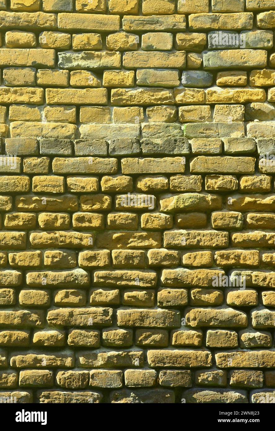 Vertical wall texture of several rows of very old brickwork made of red ...