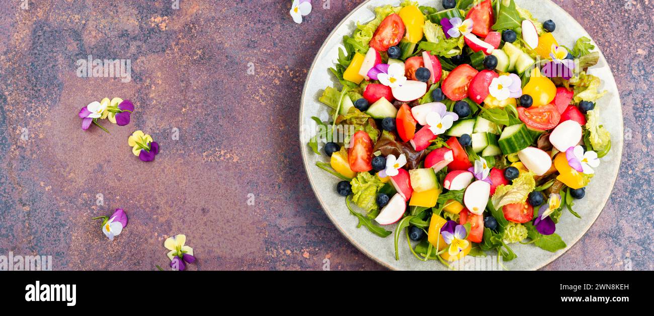 Bright vegetable salad with edible flowers. Copy space Stock Photo - Alamy