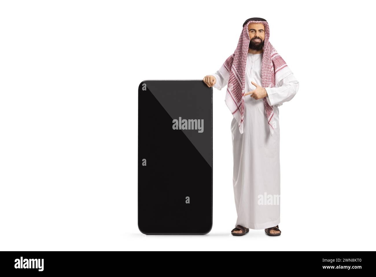 Saudi arab man in ethnic clothes pointing at a big mobile phone with ...