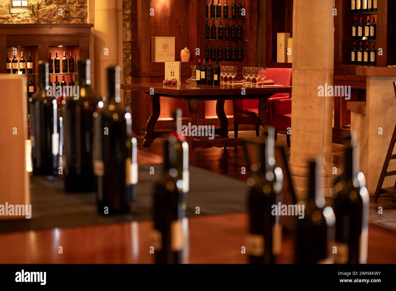 The wine bottles lined up on the counter with a bar in a winery Stock ...