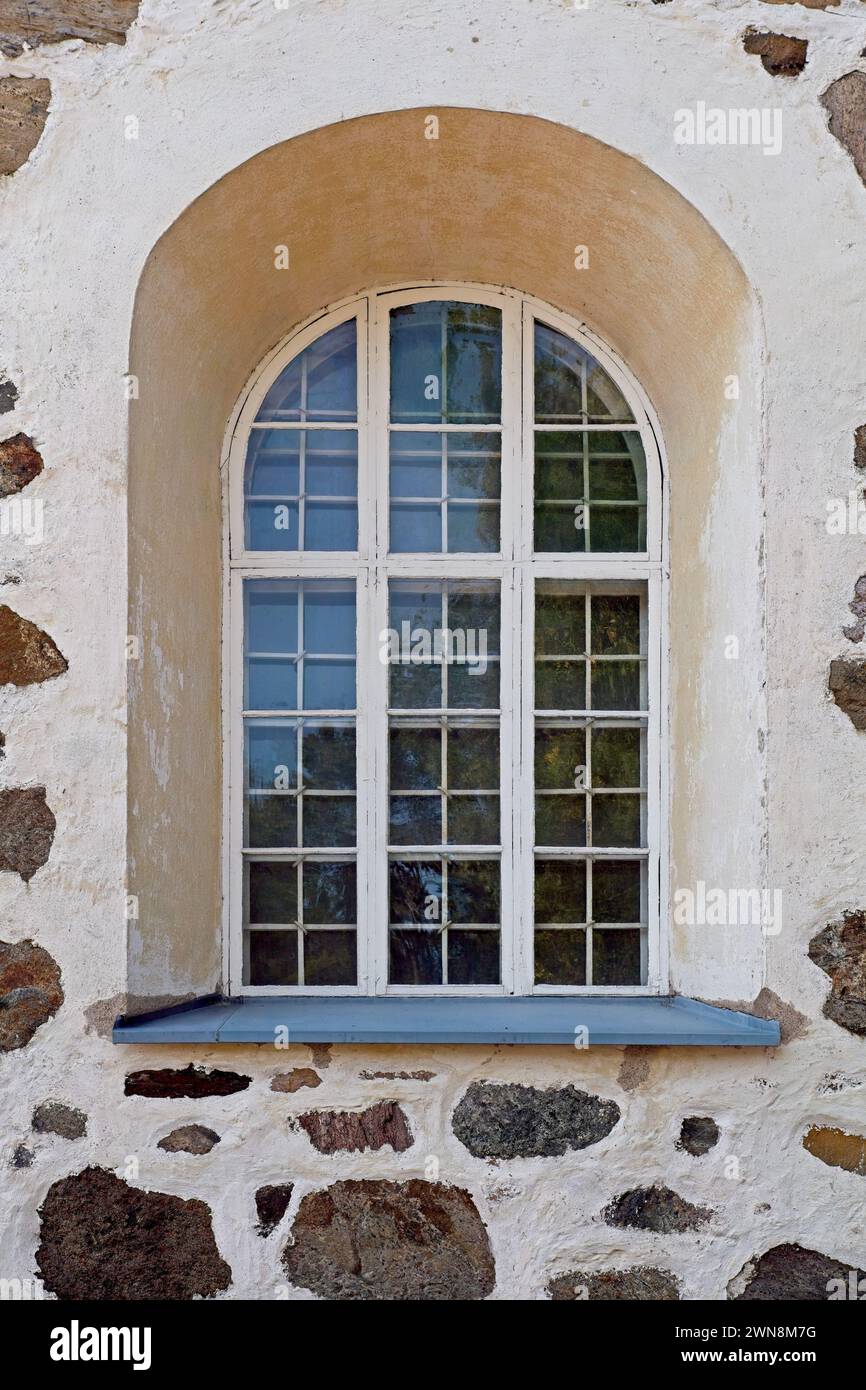 Old stone wall with white painted frame window with an arch Stock Photo ...