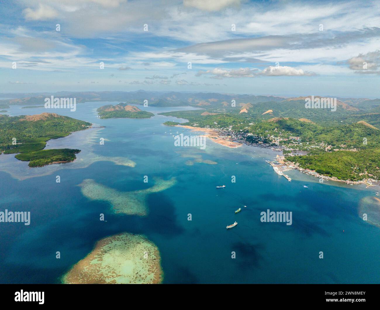 Drone view of Islands and Coron Town Proper. Blue sea with ferry and ...