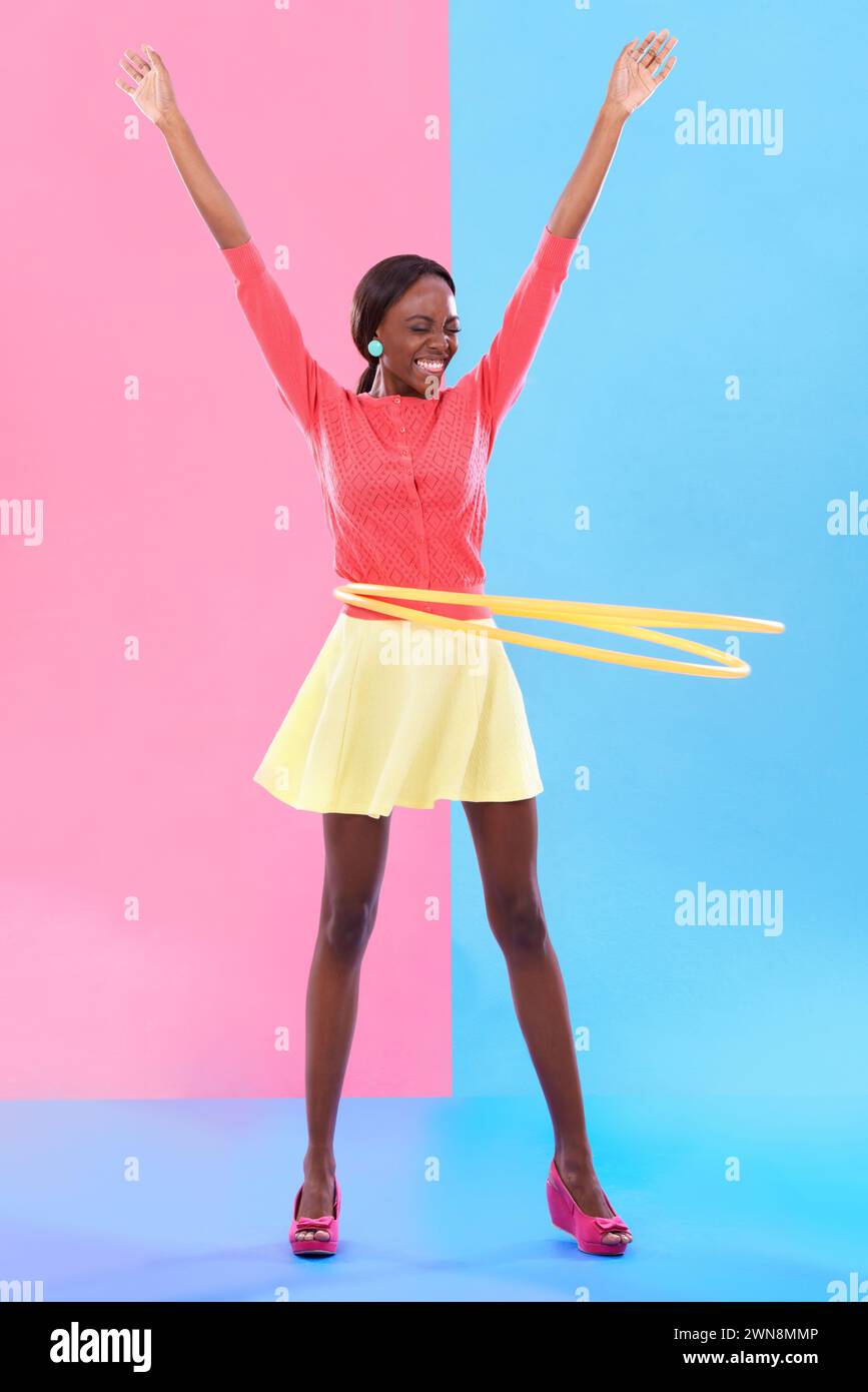 Woman, smile and hand up for victory, dance and hoop for success on ...