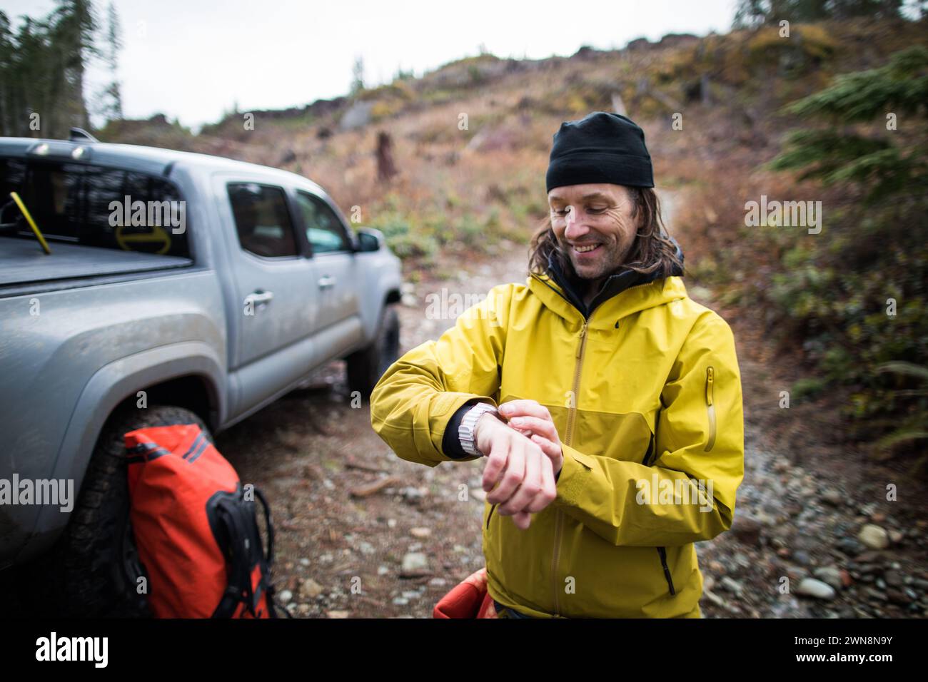 Active man starts activity tracking on his watch before a hike Stock ...