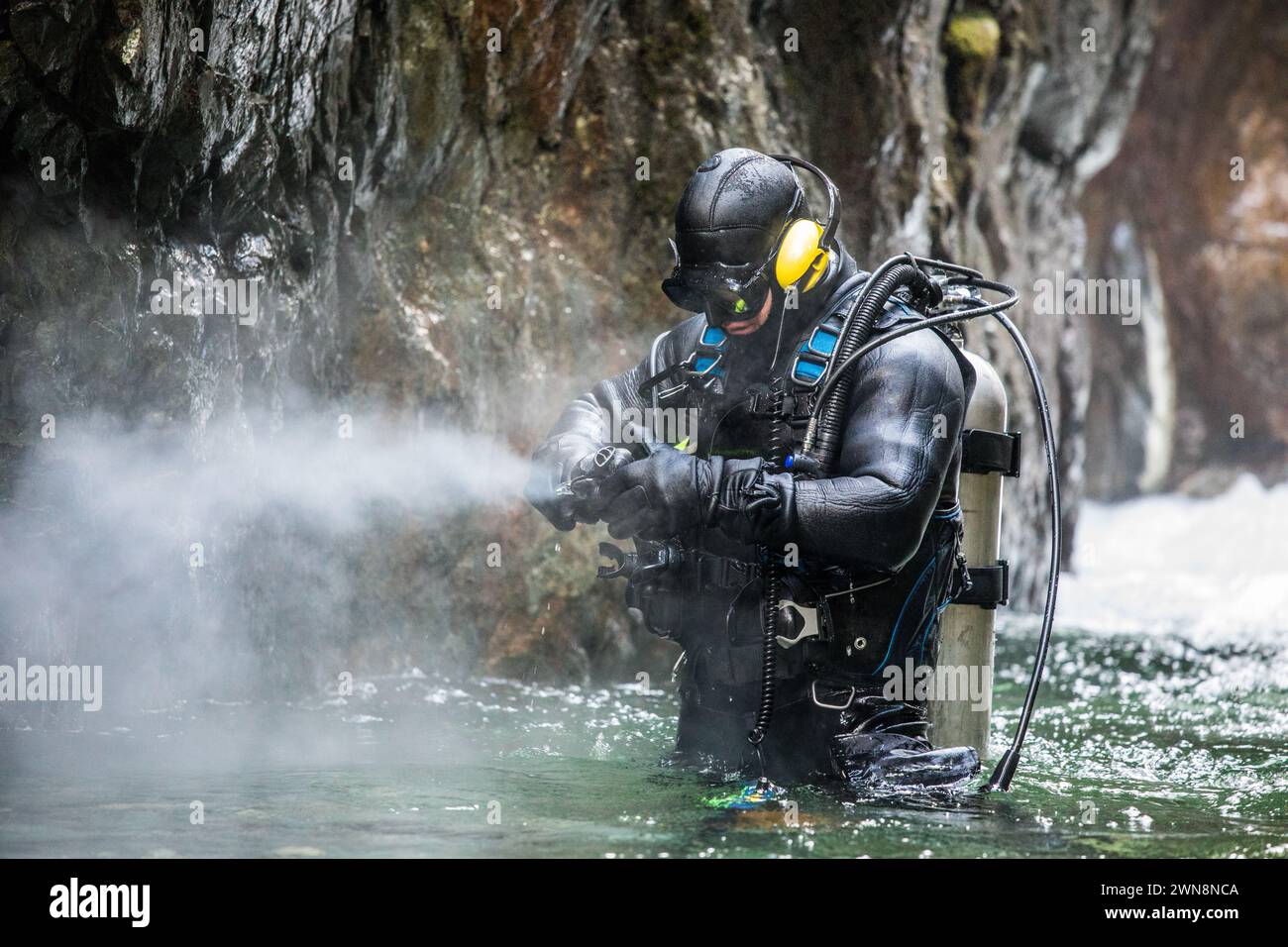 Regulator malfunctioning for scuba diver, assessing problem Stock Photo ...