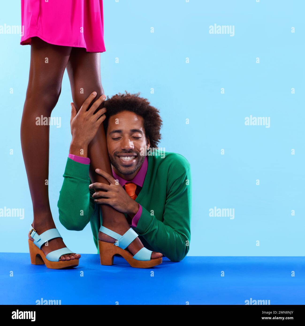 Couple, studio and smile with color, fashion and love with relationship ...