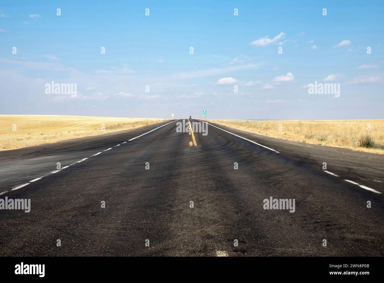 Open road trip in Eastern Washington with blue skies and golden fields ...
