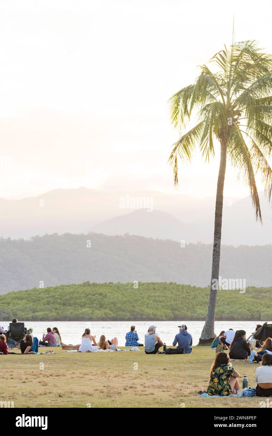 People gathered in the late afternoon at the palm tree lined park at ...