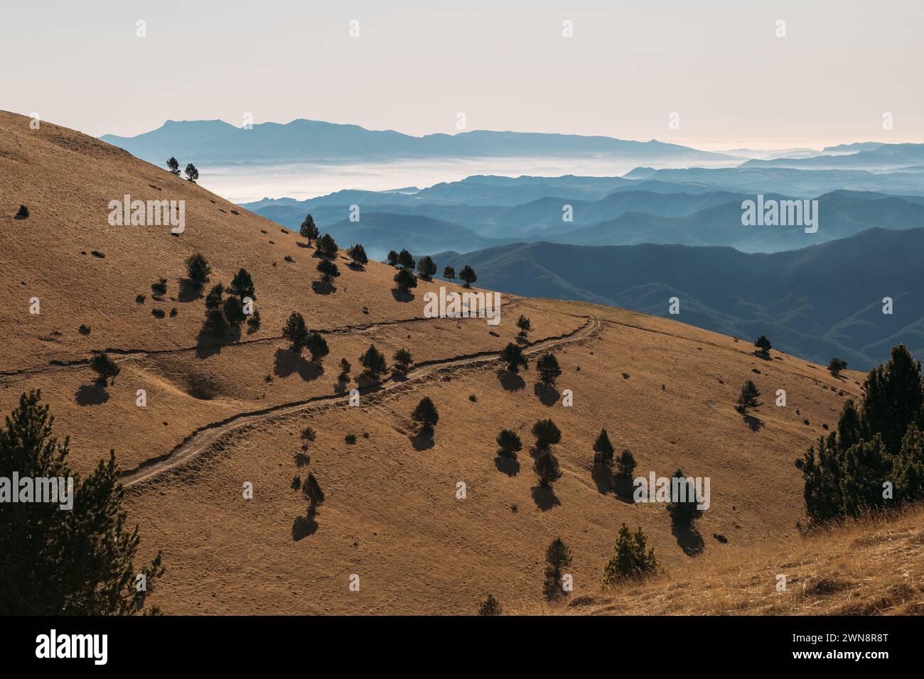 Undulating Mountain Terrain Bathed in the Warmth of the Sun Stock Photo ...
