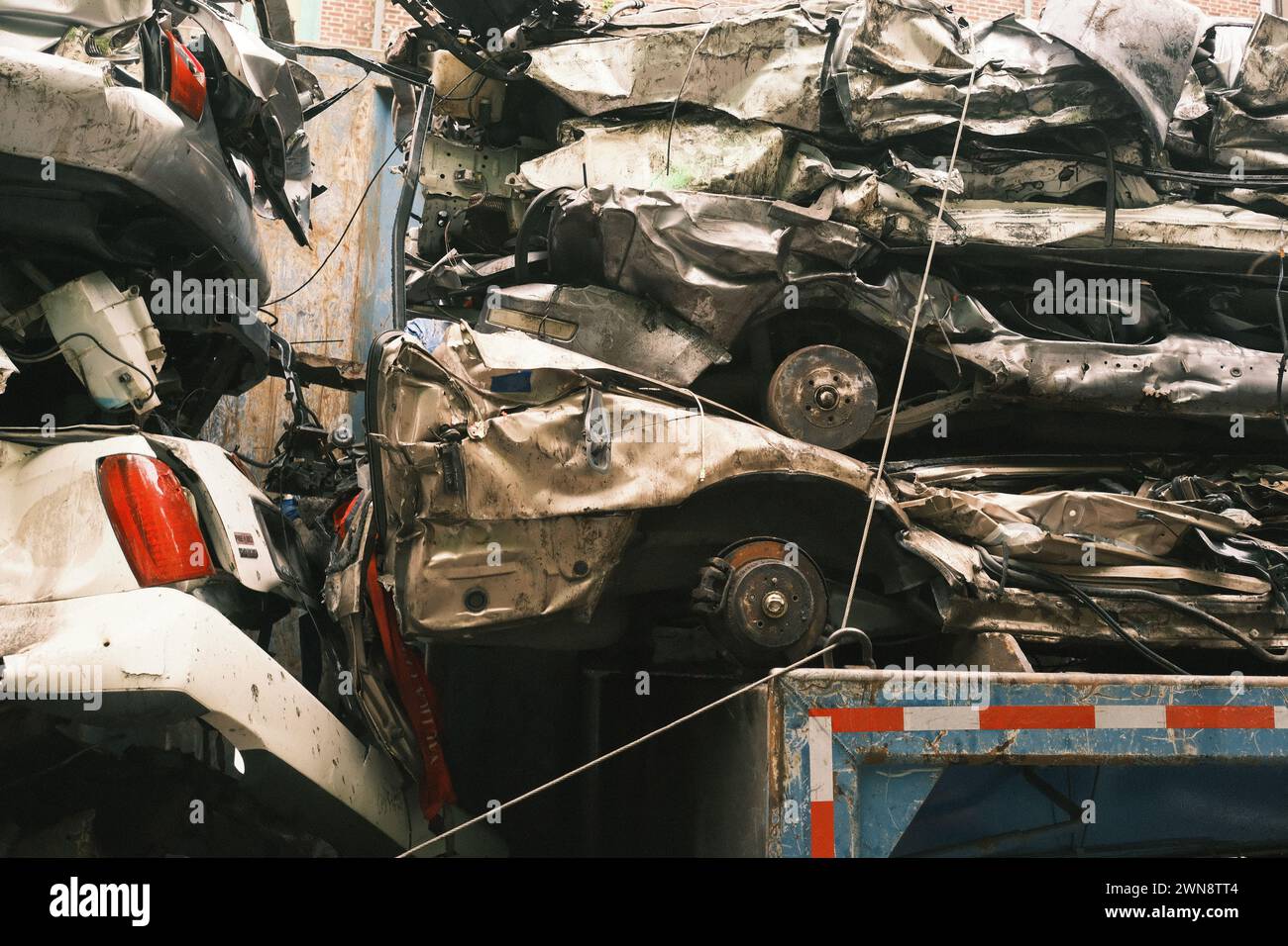 Crushed recycled cars are hauled away Stock Photo - Alamy
