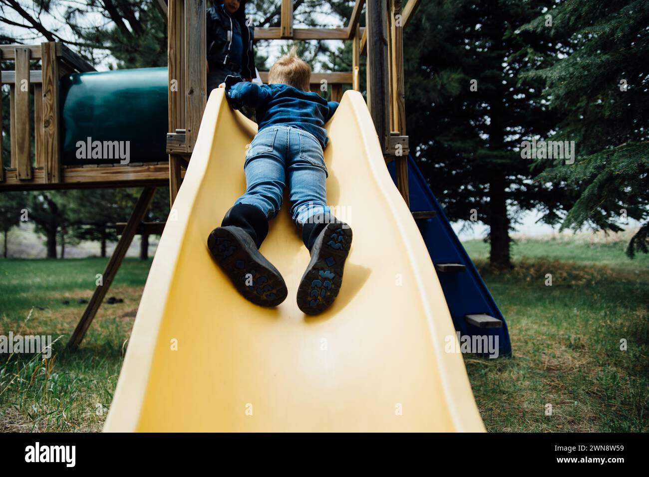 Boy on swingset hi-res stock photography and images - Alamy