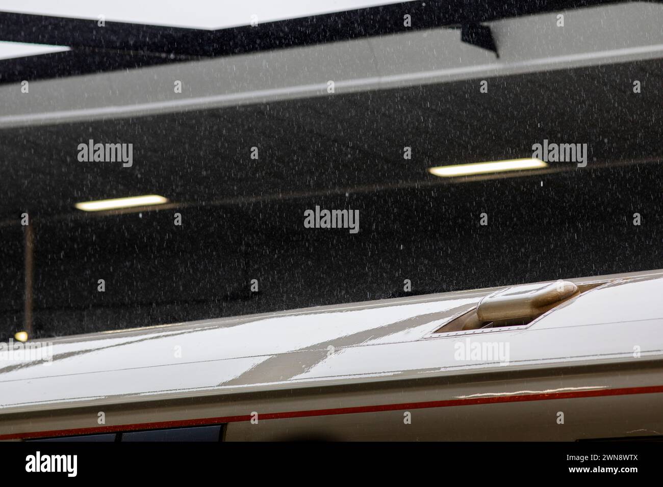 Heavy rain falling above a railway carriage at London Bridge station ...