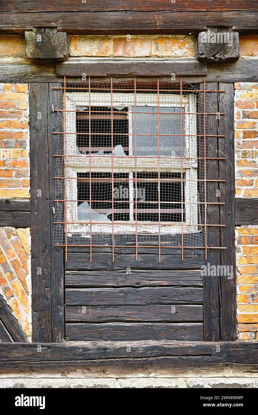 Old, broken window and exterior with cage or brick wall of abandoned ...