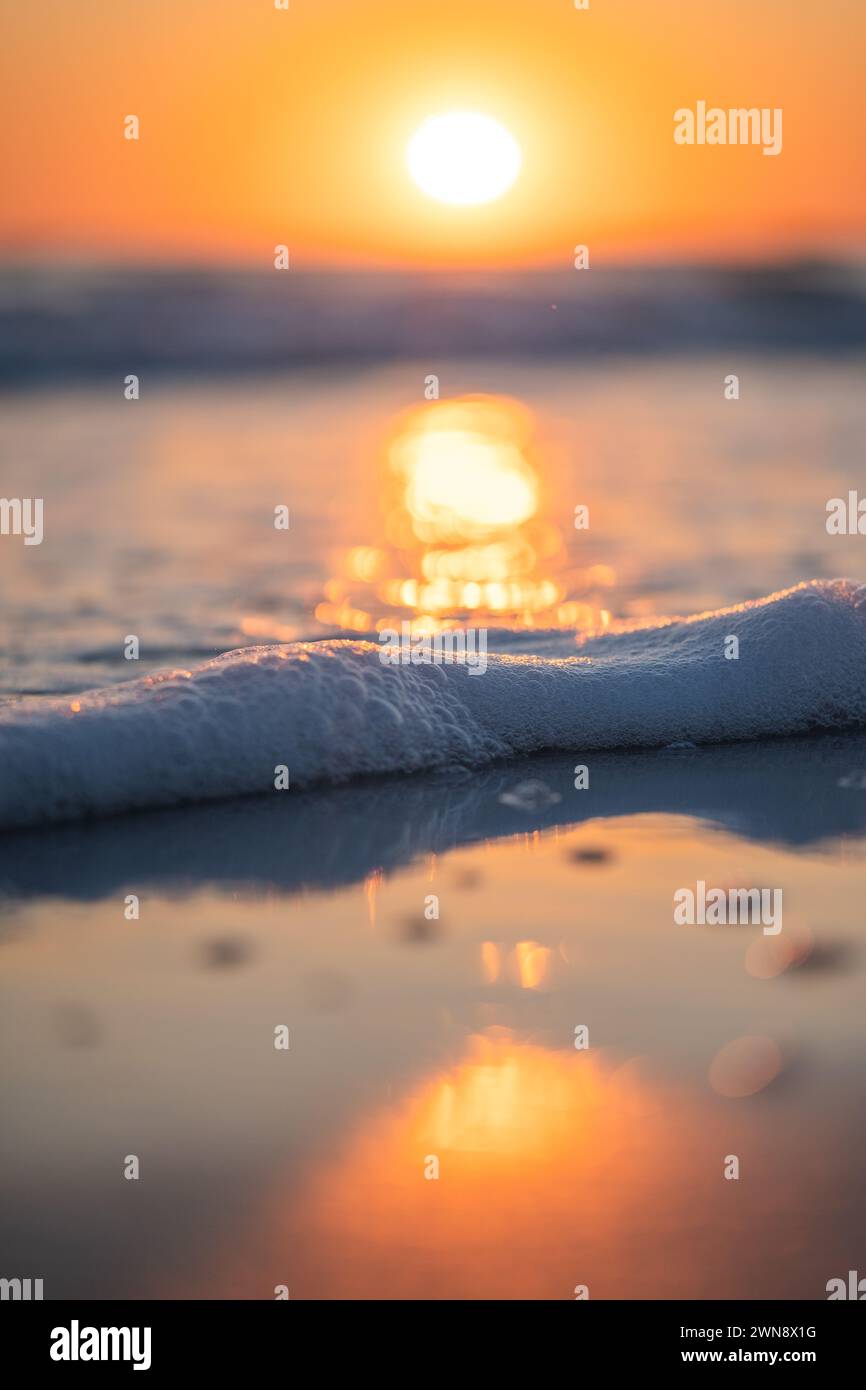 Sun going down on the ocean Stock Photo - Alamy