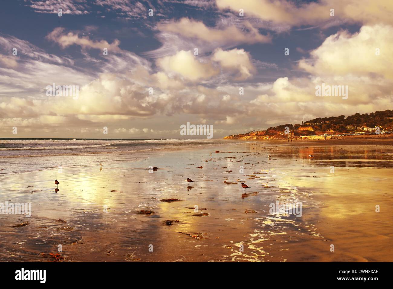 Ocean, sunset and clouds in blue sky by horizon and island and tourist ...