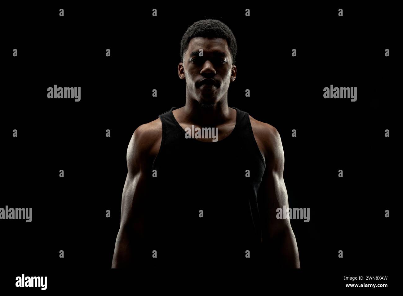 Basketball player against black background. Serious concentrated ...
